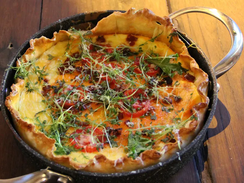 Provencal quiche, arugula and an anchovy vinaigrette